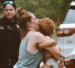 Missing boy is found being protected boy his family dogs