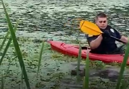 Police officer saves drowning dog using his kayak
