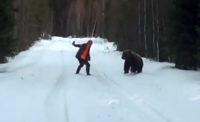 Bear runs up to attack but man scares him instead