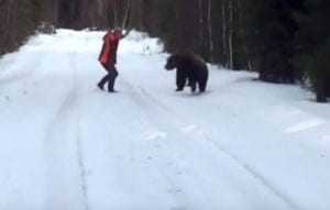Bear runs up to attack but man scares him instead