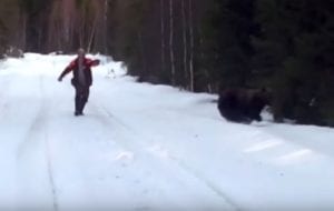 Bear runs up to attack but man scares him instead