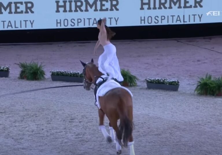 Woman stands on horse then proceeds to do a back flip mid ride